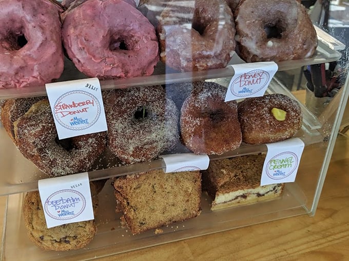 A tempting display case showcases fresh donuts in flavors that make choosing just one feel like Sophie's Choice.