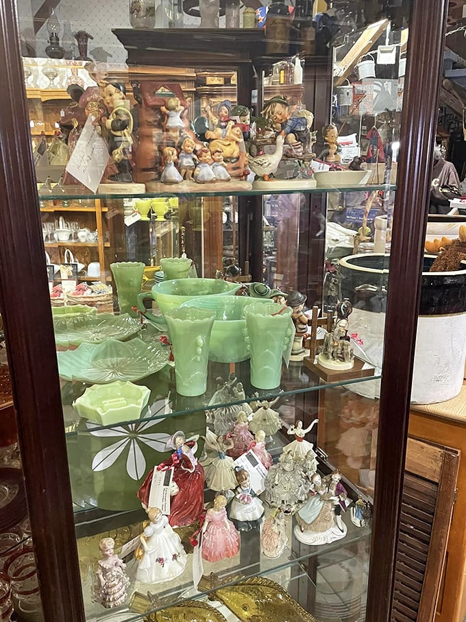 It's a curio cabinet come to life! From dainty figurines to jade-hued glassware, this display is a feast for the eyes and a playground for the imagination.