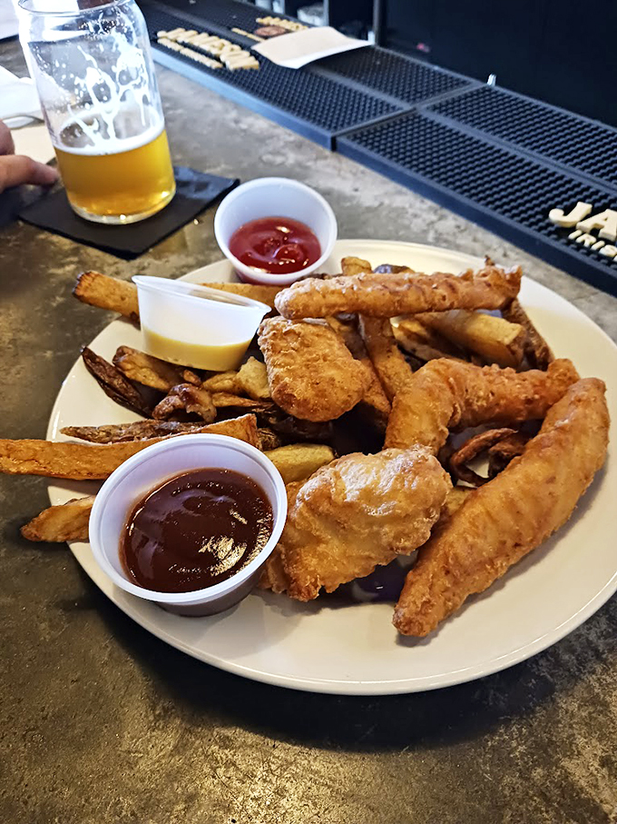 Golden-brown fish and chips that would make Neptune himself swim to shore, served with two dipping sauces. Photo credit: karen dube