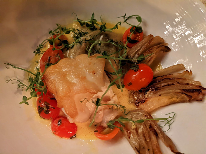 Fresh fish meets garden bounty in this artful composition, where every element plays its part in perfect harmony. Photo credit: Justin