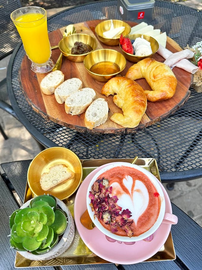 A breakfast spread worthy of first class, featuring fresh croissants and artfully presented accompaniments on elegant brass serving dishes.