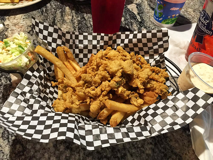 A mountain of fried seafood that's worth climbing, served with creamy coleslaw that adds the perfect fresh crunch. Photo credit: Food L.