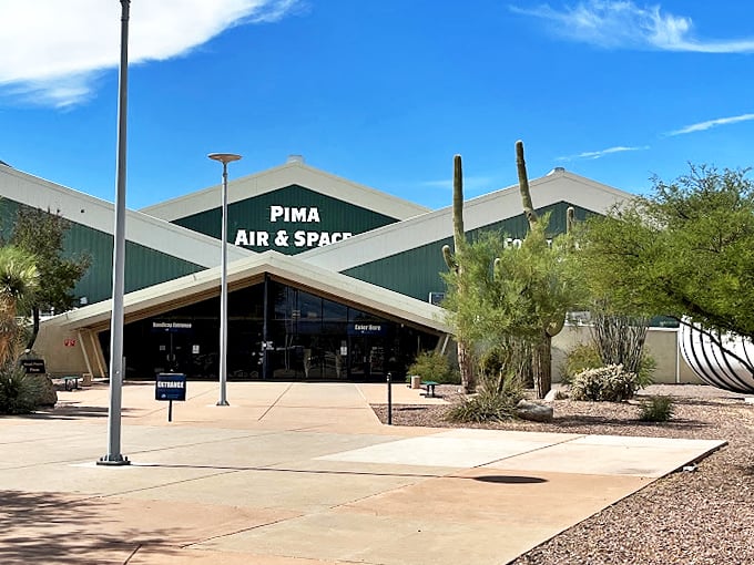 Desert landscaping meets aerospace innovation at this modern facility, where saguaros stand sentinel beside aviation history