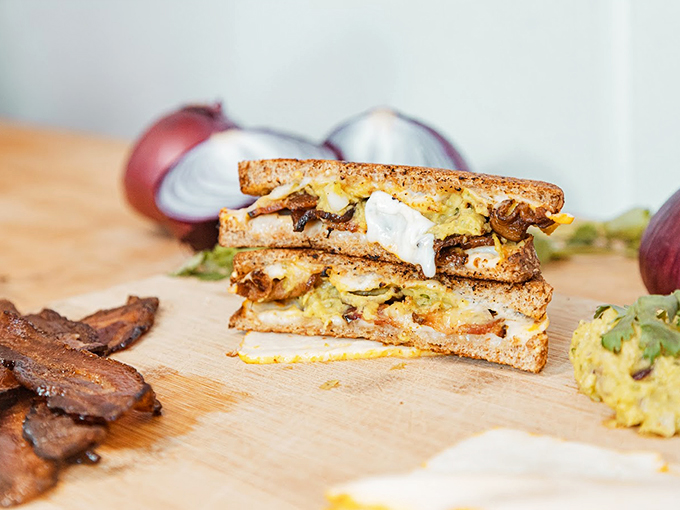 A cross-section reveals the true art of grilled cheese &ndash; layers of melted goodness between perfectly toasted bread. Photo credit: Cheese Louise Portland