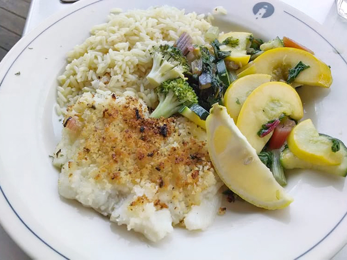 Simple perfection on a plate: Fresh haddock with rice pilaf and seasonal vegetables that let the seafood be the star.