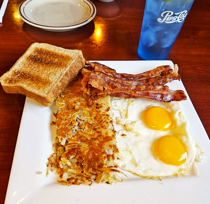 Golden-crisp hashbrowns, perfectly runny eggs, and bacon that could make a vegetarian question their life choices.