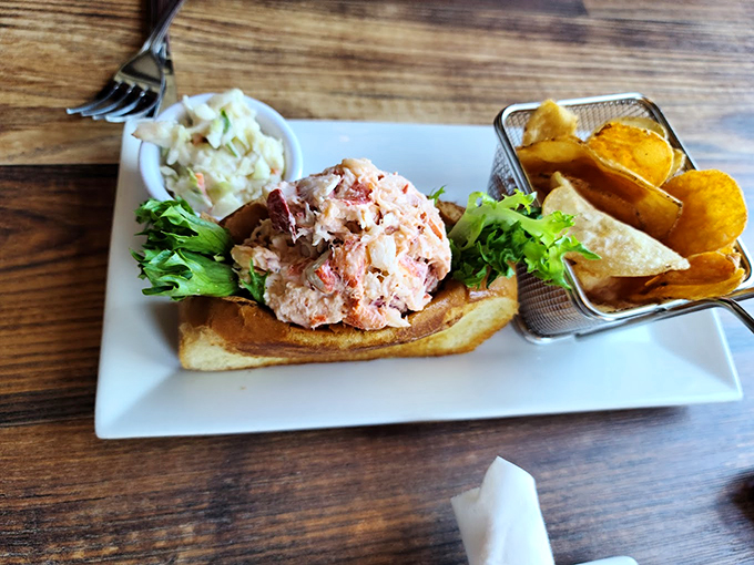 A perfect lobster roll, generously stuffed and served with house-made chips - simplicity at its finest.