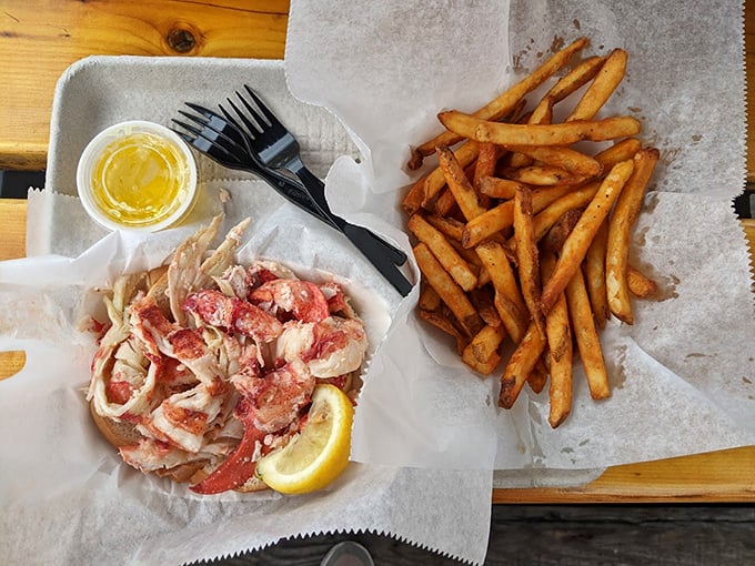 Simple perfection: Fresh lobster meat meets buttery roll, while crispy fries stand ready for their supporting role. Photo credit: Kelly Walsh