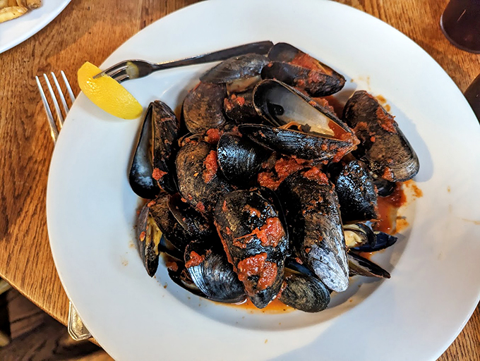 Fra Diavolo mussels swimming in a spicy tomato sauce &ndash; these black beauties pack enough heat to warm up any Vermont evening.