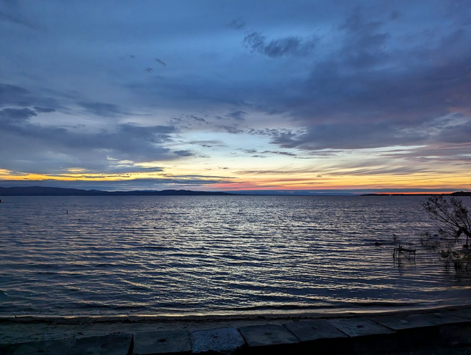 Gentle waves lap at the shoreline near the Earth Clock, creating a peaceful soundtrack for time's slow dance.