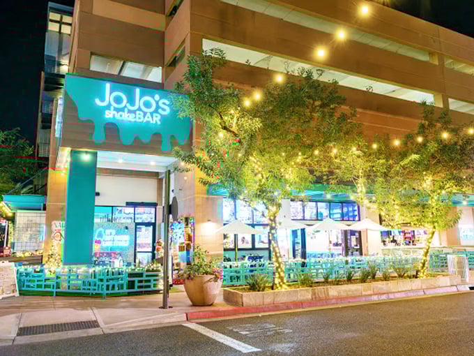 After dark, JoJo's transforms into a glowing beacon of nostalgia, with twinkling lights creating an almost magical atmosphere.