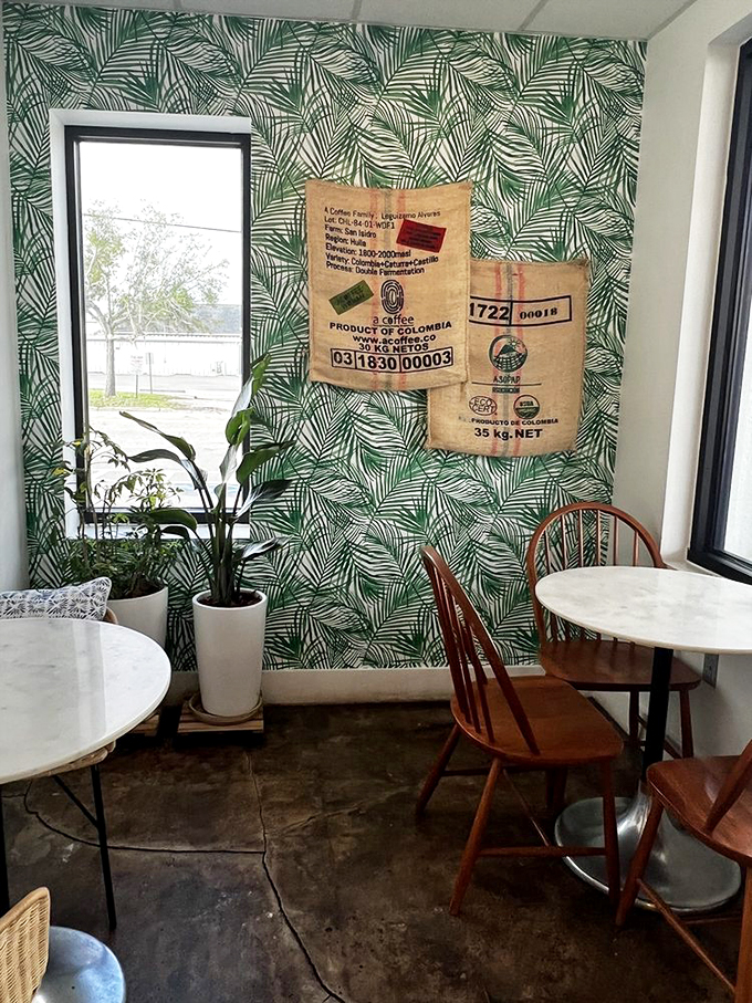 Tropical wallpaper and vintage coffee sacks transform this corner into an Instagram-worthy tropical coffee paradise.