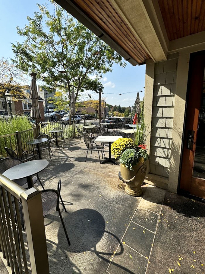 Fall mums and string lights transform this outdoor space into a magical dining garden overlooking Petoskey's historic downtown.