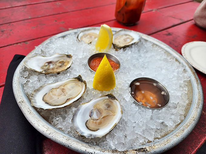 Fresh oysters on ice, glistening like pearls, with classic accompaniments that let the ocean's flavors shine.