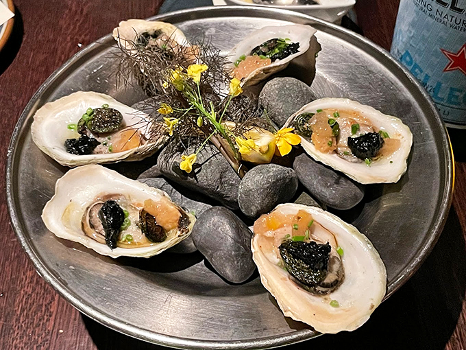 These oysters aren't just served&mdash;they're presented like precious jewels on a bed of Maine stones, garnished with edible flowers. Photo credit: Eric M