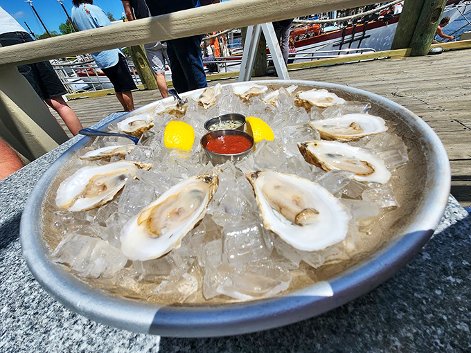 Fresh oysters on ice, arranged like pearls in a jewelry box, with zesty cocktail sauce standing by for the perfect bite.