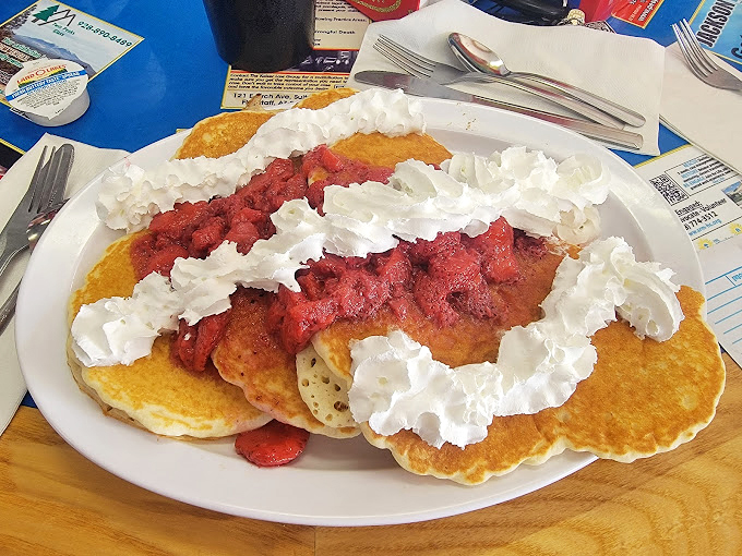 Fluffy clouds of joy topped with strawberries and whipped cream - because sometimes breakfast should feel like dessert.