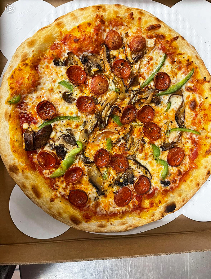 Pepperoni and mushrooms play a delicious game of connect-the-dots across this perfectly charred pizza canvas.