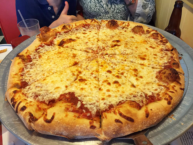 Golden-brown crust cradles a blanket of melted cheese and sauce - this isn't just pizza, it's edible artwork.