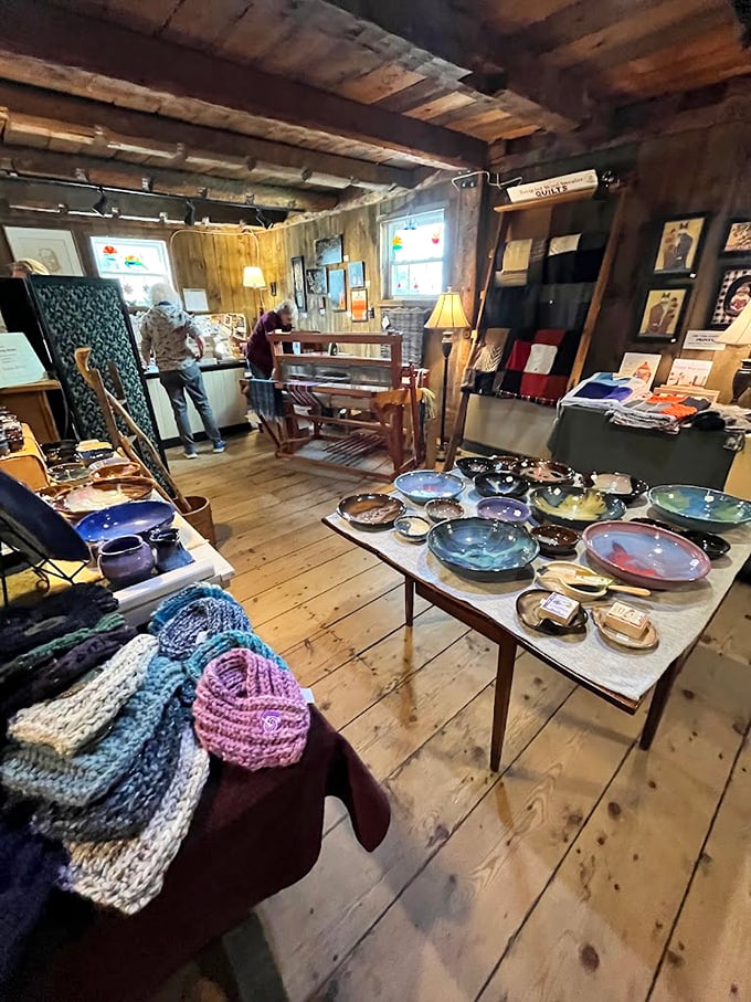 Wooden shelves showcase Vermont-made pottery and crafts, while table lamps cast a warm glow that makes everything look like home.