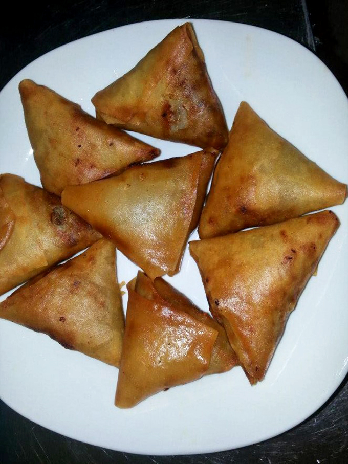 Golden-brown triangles of happiness! These sambusas are like the Ferrari of hand pies - sleek, perfectly crafted, and impossible to resist.
