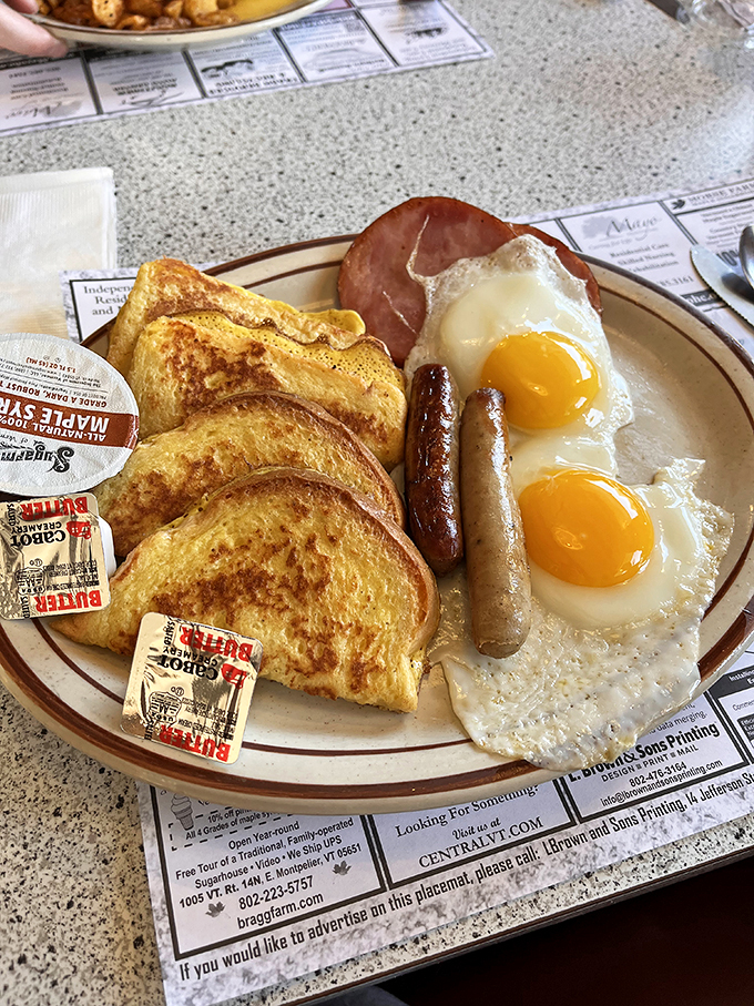 A breakfast trinity: golden toast, sunny eggs, and sausages that could make a vegetarian reconsider their life choices.