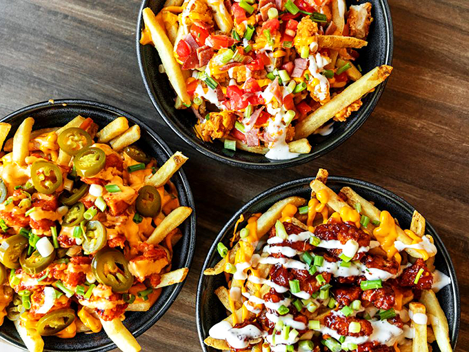 These loaded fries aren't just a side dish – they're a main event topped with enough deliciousness to make sharing optional.