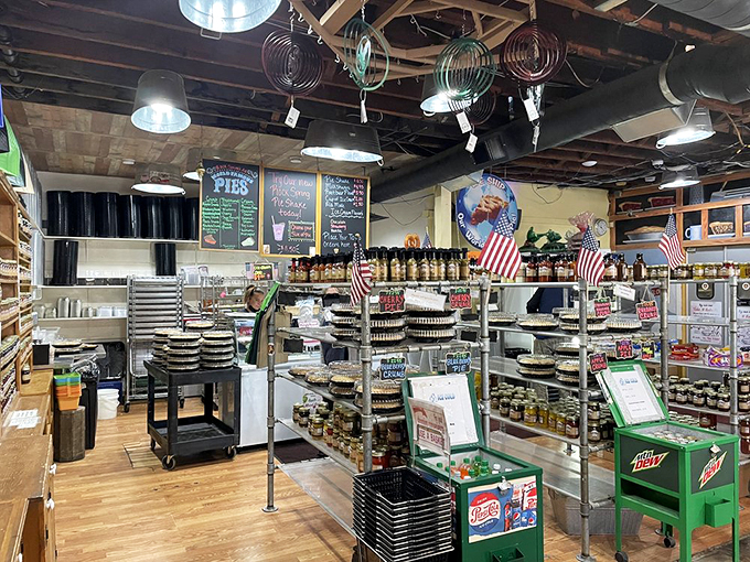 A treasure trove of homemade preserves and local treats fills shelves beneath exposed wooden beams.