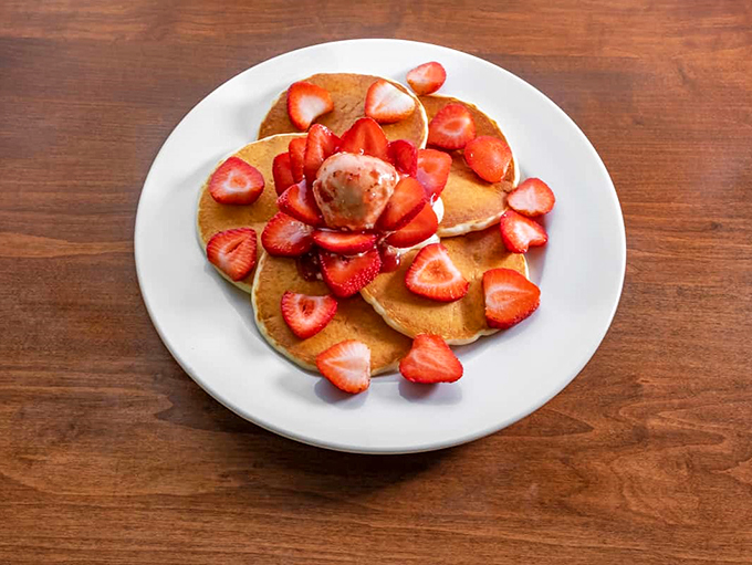 Pancakes blooming with strawberries &ndash; it's like spring decided to crash your breakfast party.