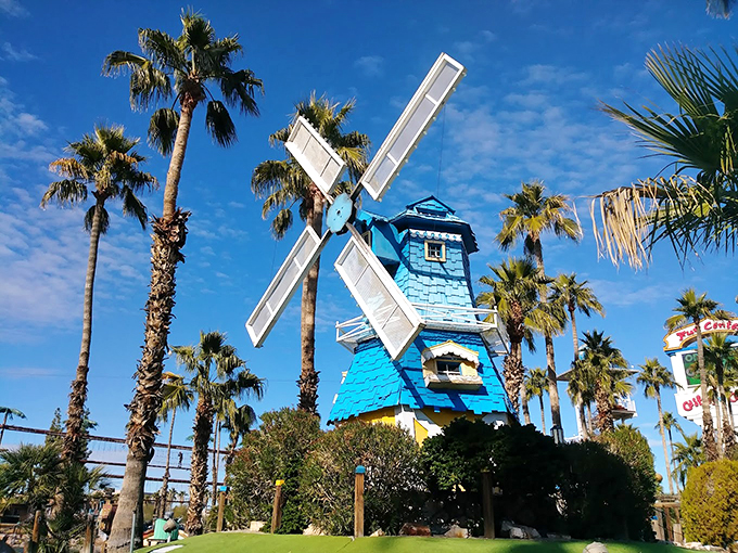 Don Quixote would be proud! This charming blue windmill stands tall amidst the palms, a whimsical nod to European flair in the desert.