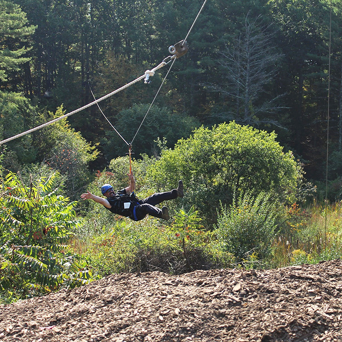 Soaring through Maine's forest canopy, zip-liners discover their inner superhero while gravity does most of the work. Photo credit: Take Flight Aerial Adventure Park