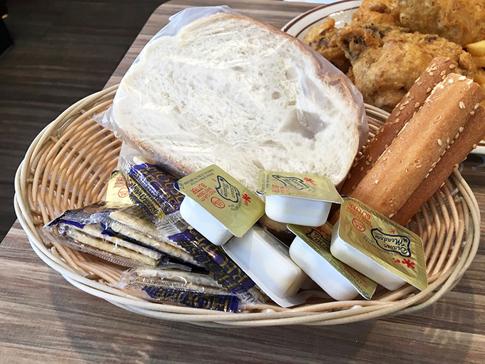 The bread basket brigade: where crackers, butter packets, and fresh rolls stand ready for their supporting role in your meal.