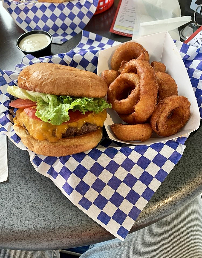 Holy moly, that's a burger! Juicy, cheesy, and stacked higher than my old yearbook. Those onion rings? They're the backup singers to this rock star sandwich.