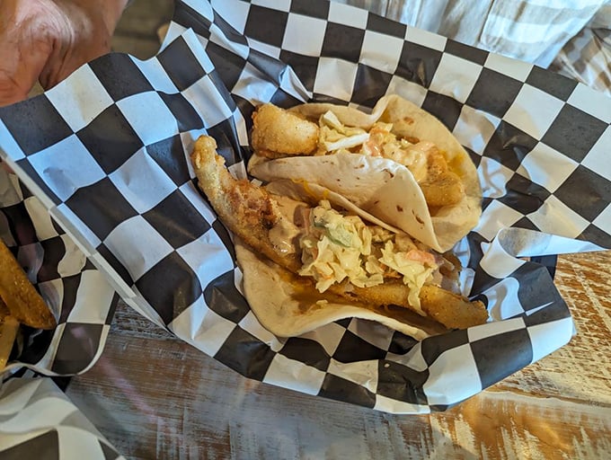 These fish tacos, nestled in their checkered paper, tell a tale of crispy perfection and fresh toppings that's worth sharing.