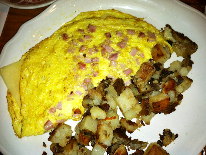 Eggs-actly what the doctor ordered! This ham and cheddar omelet, paired with those famous home fries, is comfort food at its finest.
