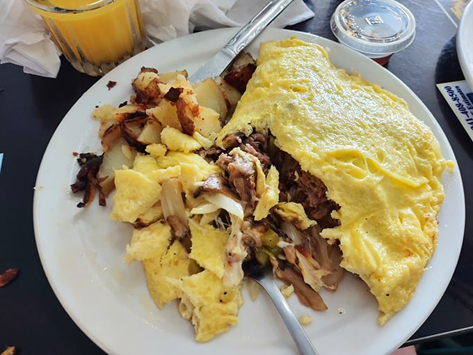 Omelet perfection achieved! This fluffy yellow masterpiece is so packed with goodies, it's like your breakfast went on a shopping spree. Photo credit: Sandra Nicholas