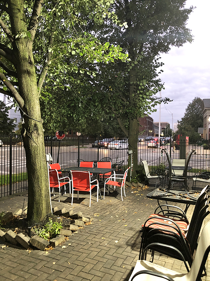 Al fresco dining, Detroit style. These red chairs aren't just seats; they're front-row tickets to the greatest show on earth: people-watching while you eat.