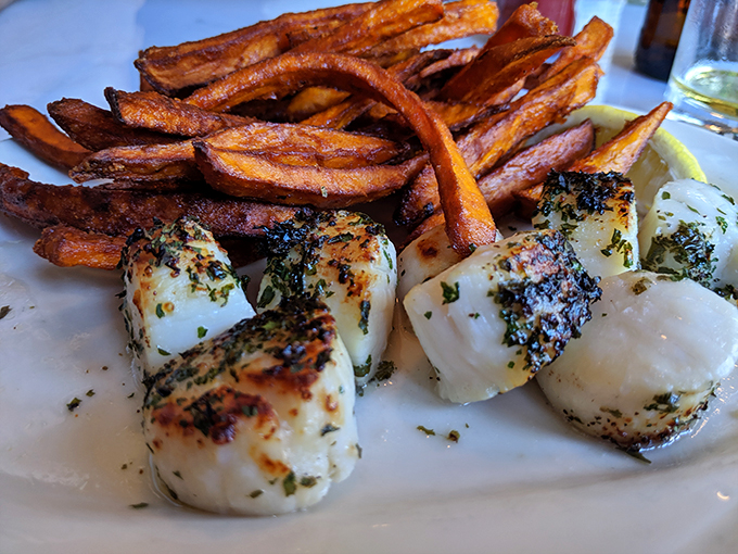 A match made in seafood heaven! Perfectly seared scallops and crispy sweet potato fries - it's like the ocean and the earth decided to throw a party on your plate.