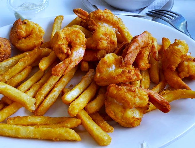 A seafood feast fit for a coastal king! This platter of golden-fried goodness proves that sometimes, the best catch of the day comes from the kitchen, not the ocean.