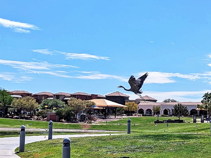 Gentle slopes of emerald grass meet crystal waters, creating a peaceful haven where desert dwellers find respite.