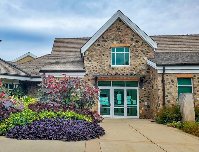 The garden's visitor center with its distinctive architecture and thoughtfully designed landscaping featuring Japanese maples and ornamental plants.