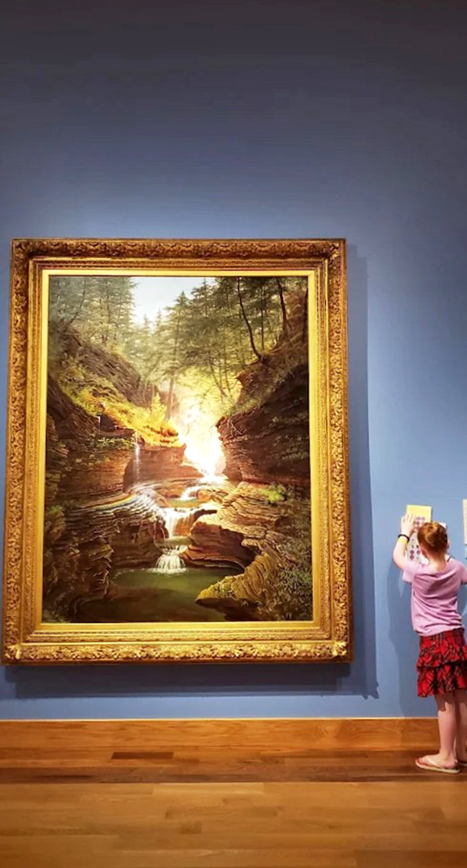 Nature's masterpiece framed in gold. This painting captures the raw beauty of a forest waterfall, no Instagram filter required.