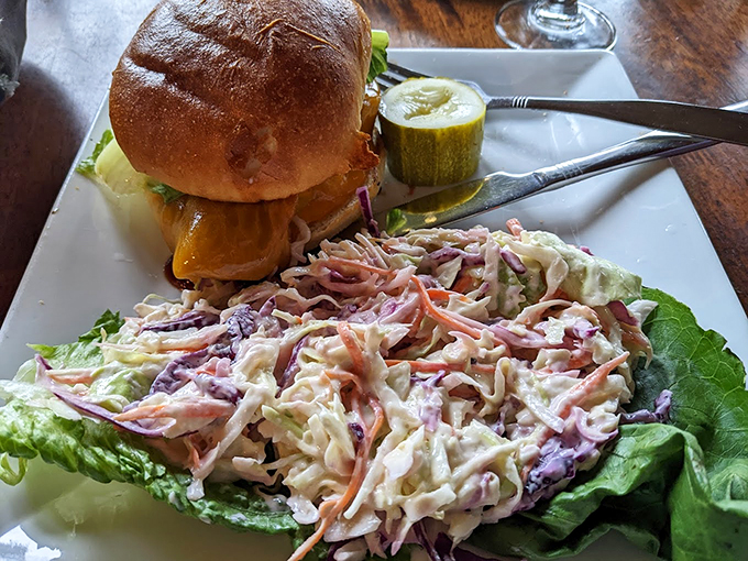 This burger arrives like a work of art, with fresh lettuce and tomato adding vibrant color to the masterpiece. Photo credit: John Bomba