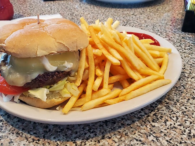 This isn't just a burger – it's a tower of classic American dreams stacked between two buns, with fries standing guard. Photo credit: Michael Murillo