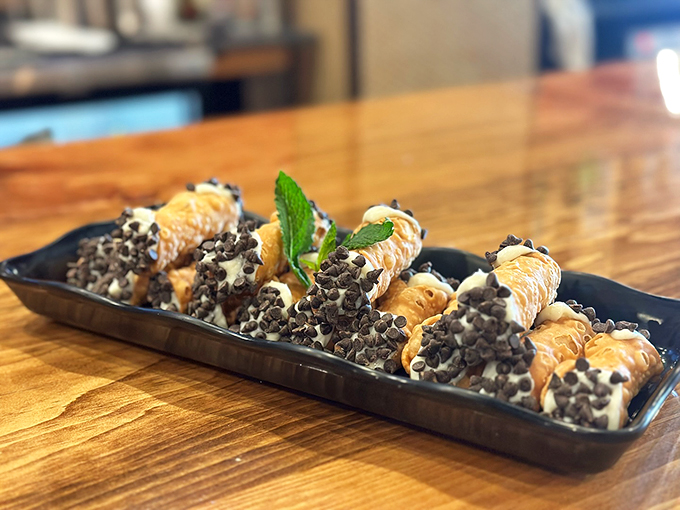 These chocolate-chip-studded cannolis aren't just dessert - they're little tubes of happiness with a mint leaf crown.