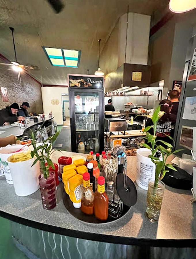 The bustling counter area serves as command central, where coffee flows freely and breakfast dreams come true.