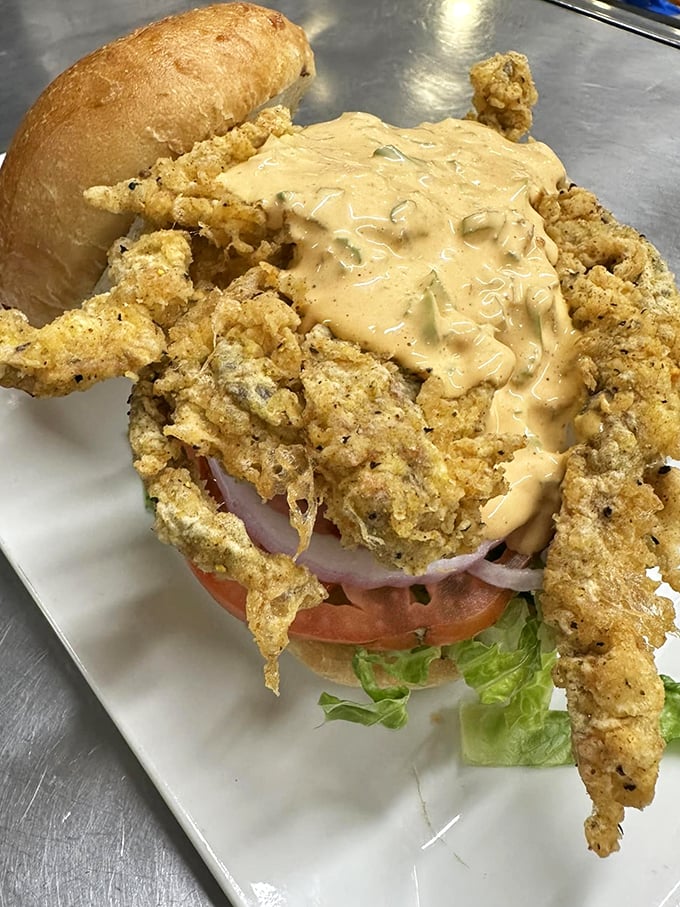 Crispy meets creamy in this masterpiece - tender fried seafood dressed in a zesty sauce on a golden bun.