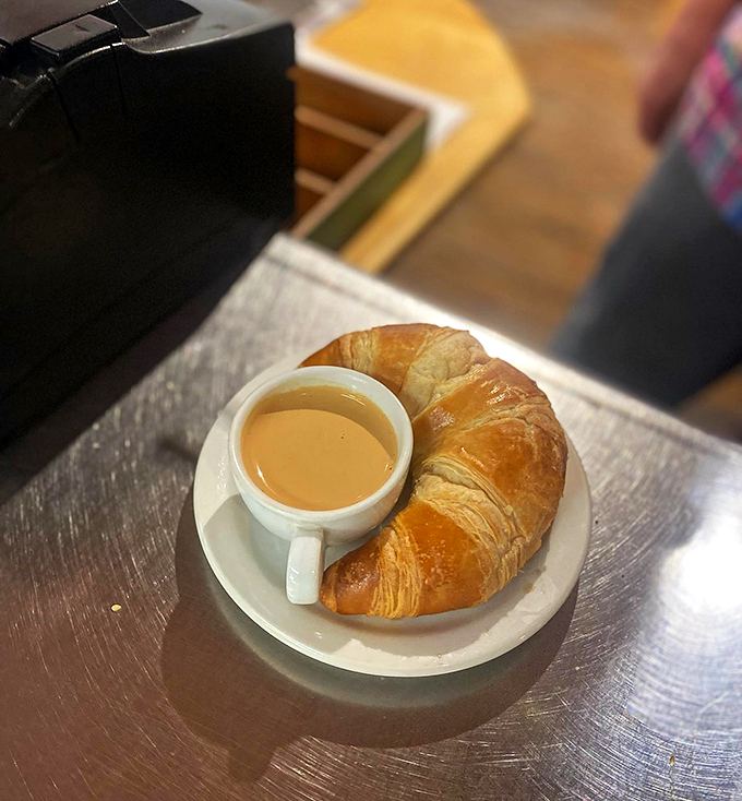 The perfect pair: a buttery croissant and creamy coffee, ready to turn your morning from meh to magnificent.