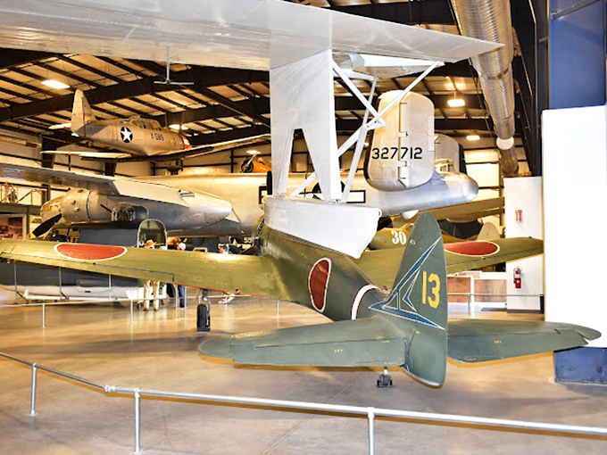 The legendary B-17 Flying Fortress commands attention, its polished aluminum skin gleaming under museum lights like a silver screen star.