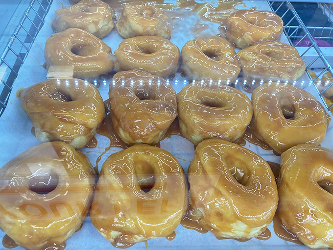 Golden glazed rings catching the light like sugary halos, proving that perfection doesn't need fancy decorations. 
